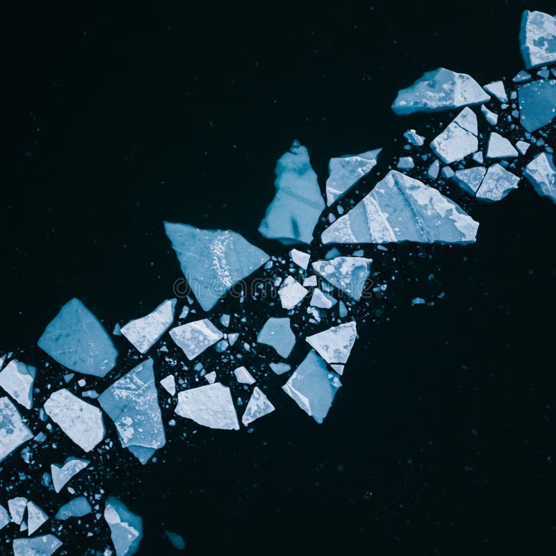 Broken Ice Fragments Float on Dark Water, Forming an Irregular Pattern ...