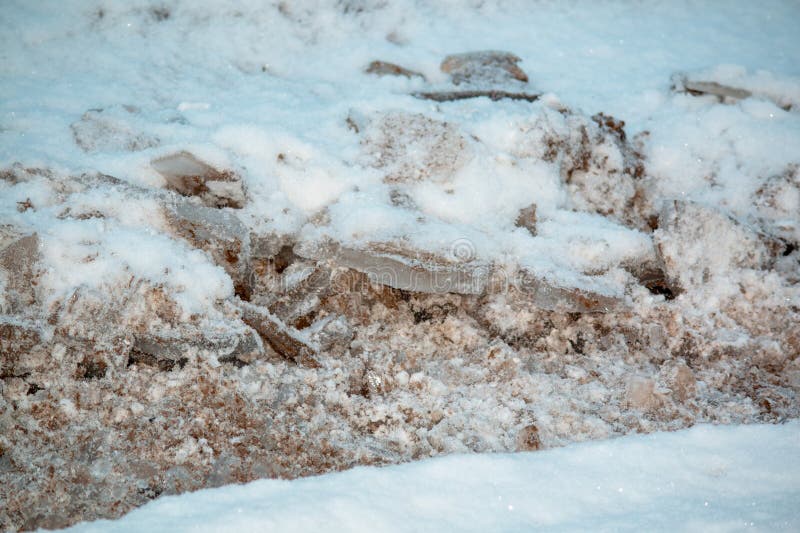 Broken Ice of a Frozen Mud Puddle Stock Photo - Image of puddle, snow ...