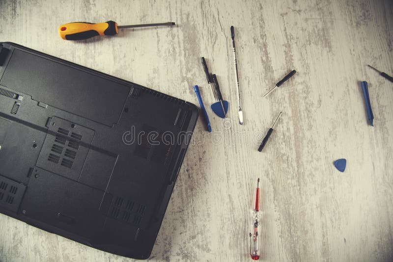 Broken laptop with tools stock photo. Image of repair - 133857788