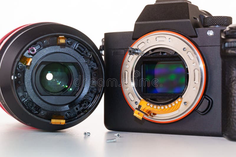 A Broken Lens, Professional Camera and Repair Tools on a White Table ...