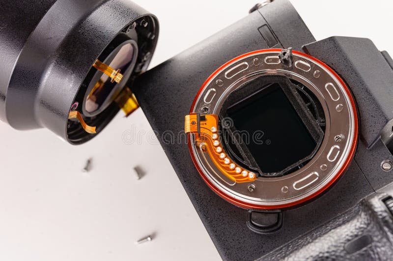 A Broken Lens, Professional Camera and Repair Tools on a White Table ...