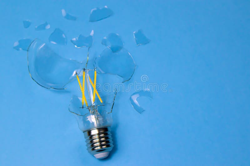 Broken Light Bulb on Blue Background Stock Photo - Image of bulb ...