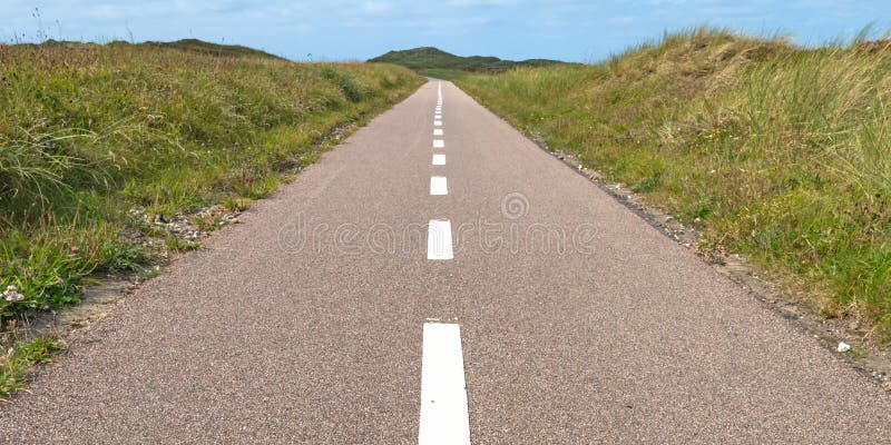 A Broken Line Asphalt Road Leads through the Dunes of Denmark Stock ...