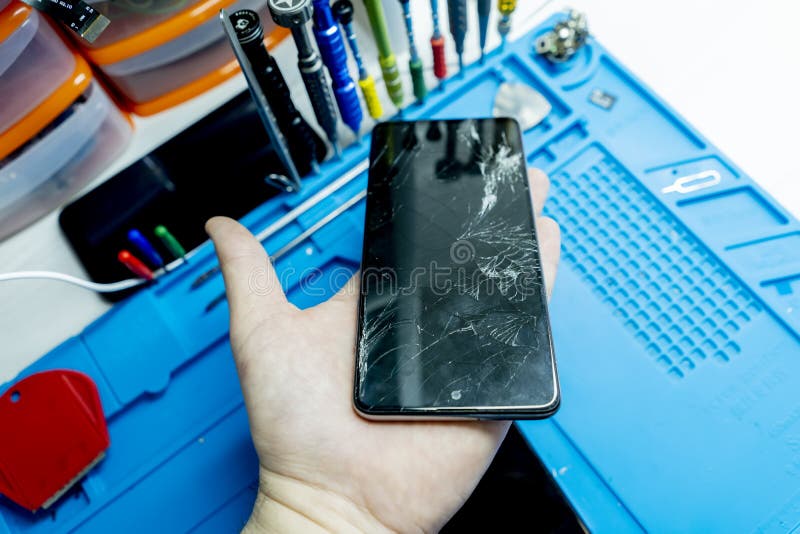 A Broken Mobile Phone Screen in the Master`s Hand Stock Image - Image ...