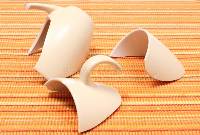 Broken Mug, Shattered Cup on Orange Cloth Stock Photo - Image of pieces ...