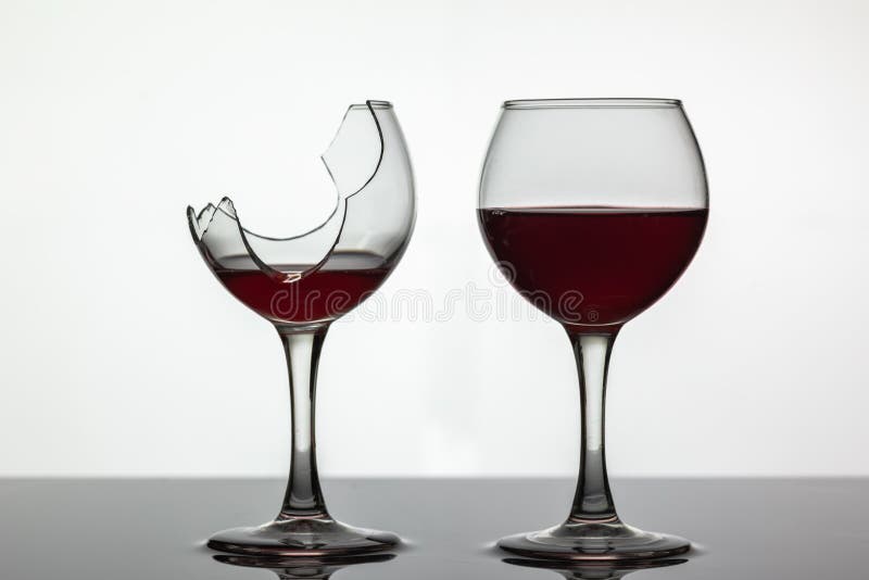 Broken and Not Broken Wine Glass with Red Wine on White Background ...