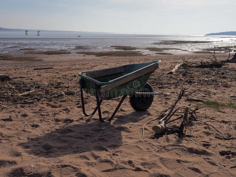 Broken Old Green Plastic Wheel Barrow on the Beach Stock Photo - Image ...
