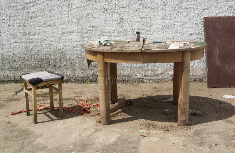 Broken Old Working Table with a Stool Outside Stock Photo - Image of ...