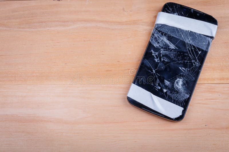 A Broken Phone on a Wooden Floor. View from Above Stock Image - Image ...