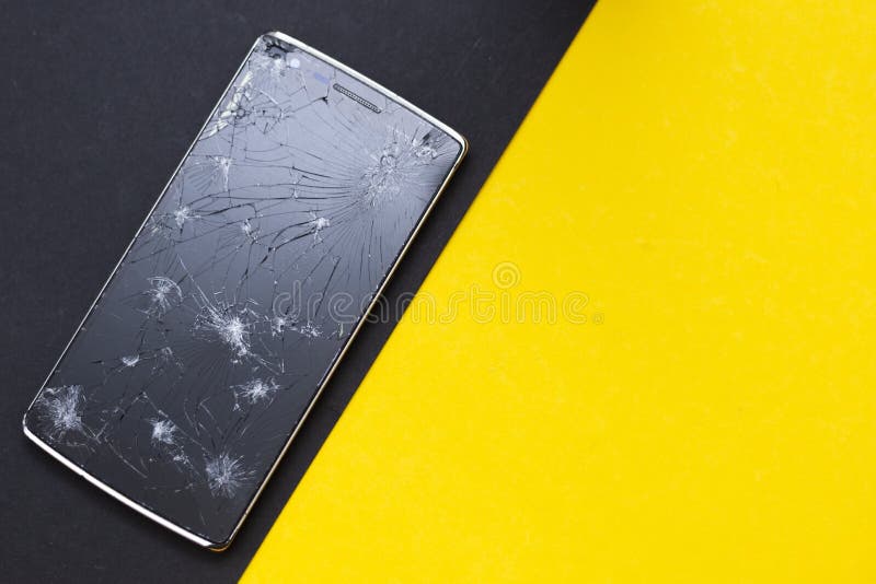 A Broken Phone on Yellow and Black Background. Crushed Device with ...