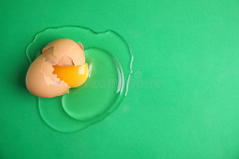 Broken Raw Egg with Shell on Green Background, Top View. Space for Text ...