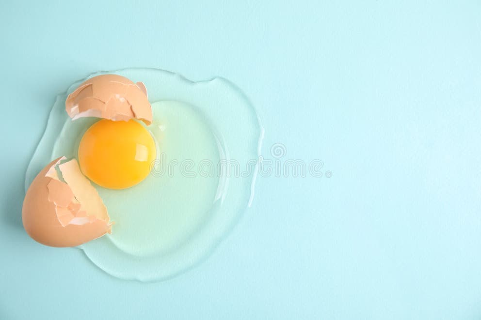 Broken Raw Egg with Shell on Light Blue Background, Top View. Space for ...