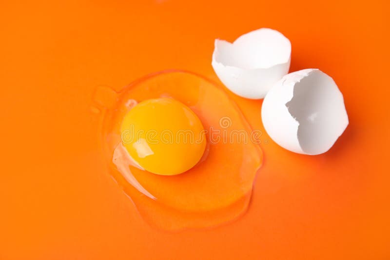 Broken Raw Egg and Shell on Orange Background, Closeup Stock Image ...