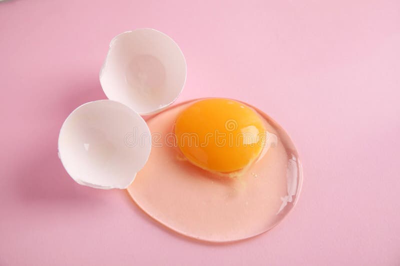 Broken Raw Egg and Shell on Pink Background, Closeup Stock Photo ...