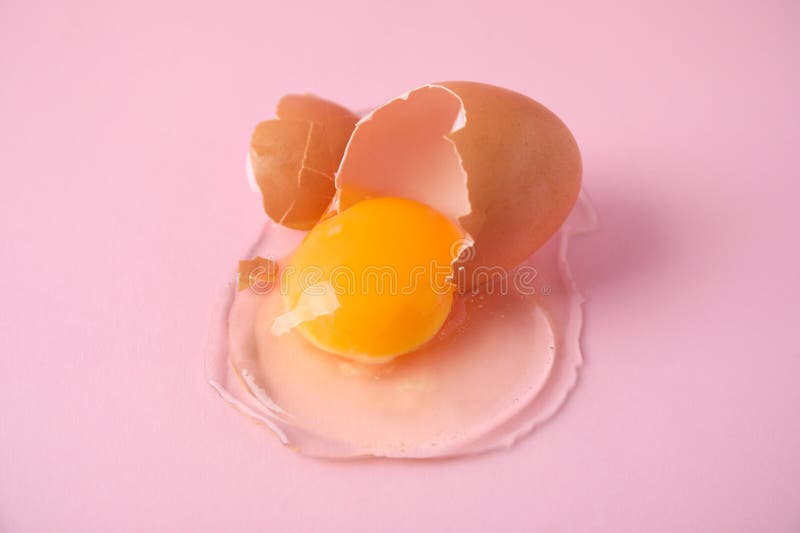 Broken Raw Egg with Shell on Pink Background, Closeup Stock Photo ...