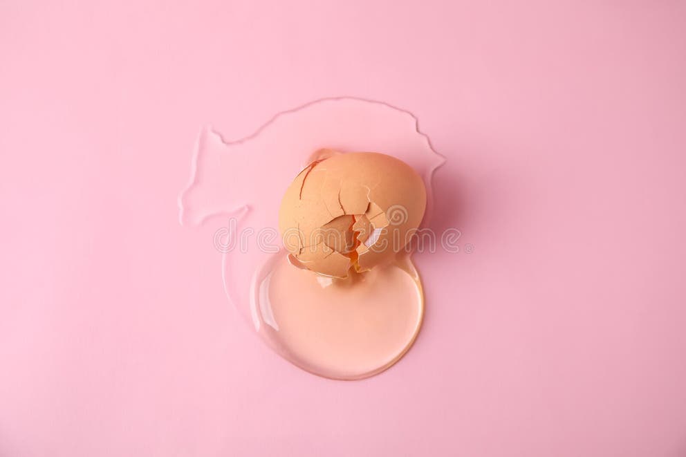 Broken Raw Egg with Shell on Pink Background, Top View Stock Photo ...
