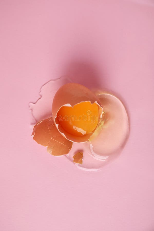 Broken Raw Egg with Shell on Pink Background, Top View Stock Image ...