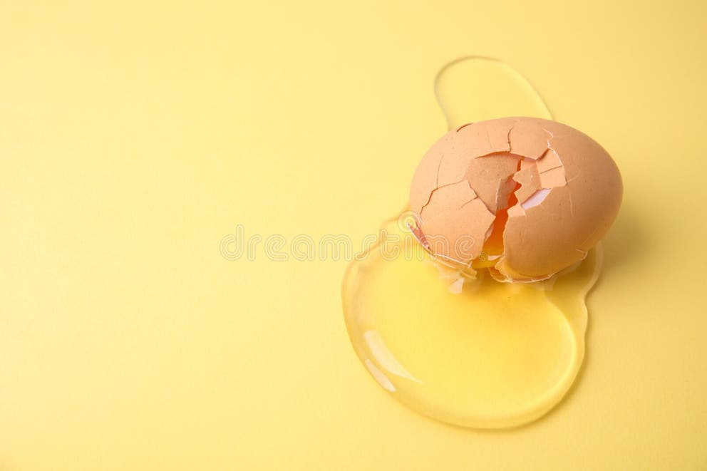 Broken Raw Egg with Shell on Yellow Background, Closeup. Space for Text ...