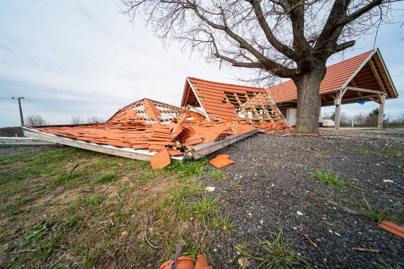 Broken roof after a storm stock image. Image of devastation - 244083827