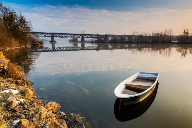 Broken Rowboat Anchored on Riverbank on Cold Winter Morning Stock Photo ...