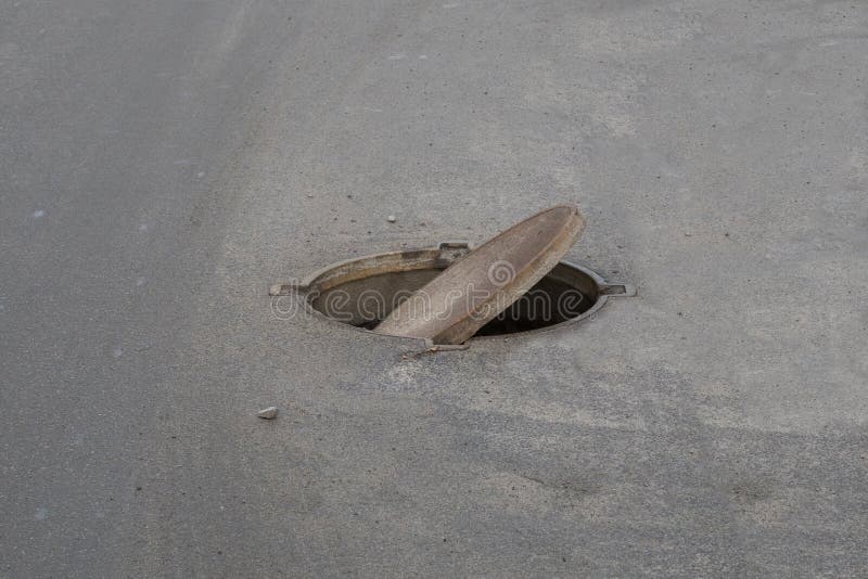 Broken Sewer Manhole Cover Dangerously Open in the Middle of the Road ...