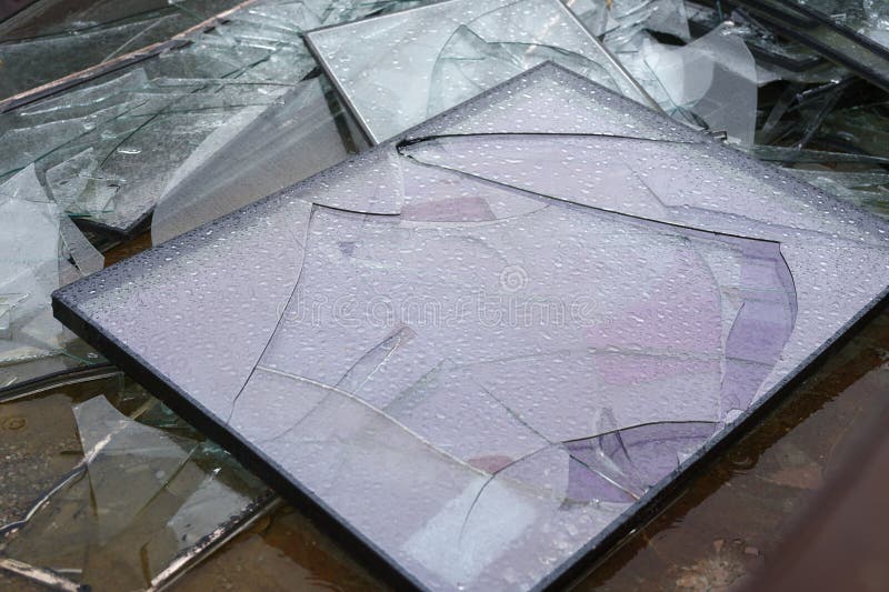 Broken and Shattered Windows and Glass Panes Lie in a Container for ...
