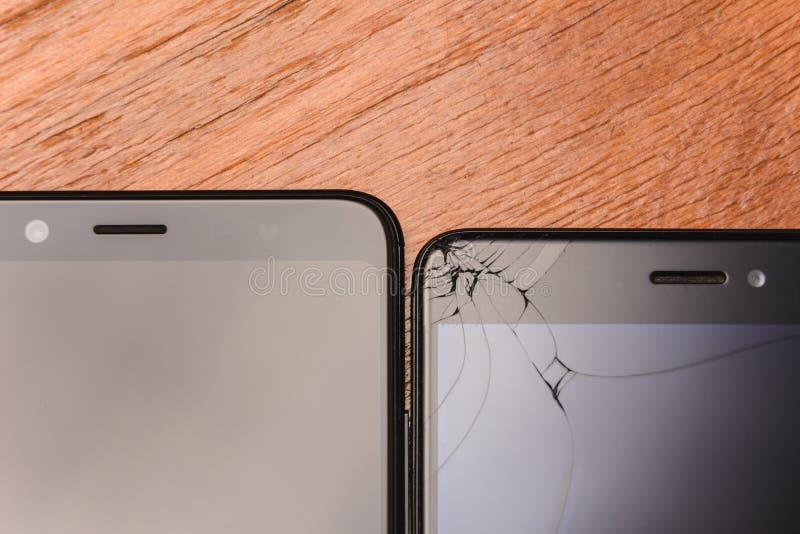 Broken Smart Phone Glass and Broken Smart Phone Glass on a Wood Table ...
