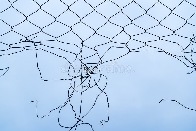 Broken Torn Chain Link Fence Against Overcast Winter Sky, Concept of ...