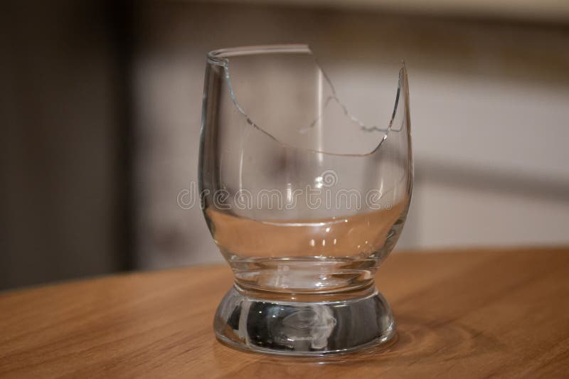 Broken Transparent Drinking Glass on the Table Stock Photo - Image of ...