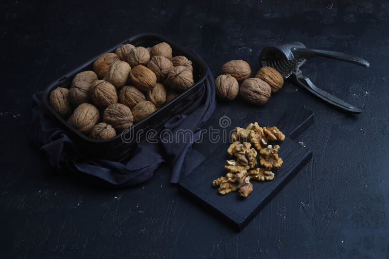 Broken Walnuts and Nutcracker on Black Background Stock Photo - Image ...