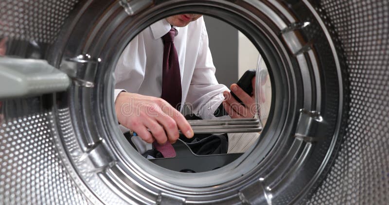 Broken Washing Machine. a Man in a Suit Speaks through His Smartphone ...