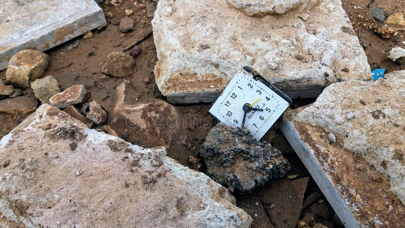 Clock on the rocks stock photo. Image of dump, clock - 107997236