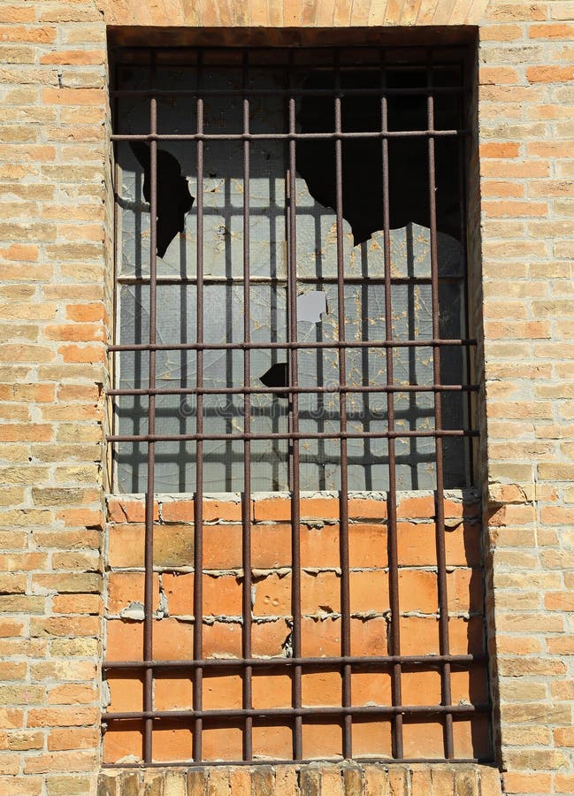 Broken Window of an Abandoned House with Iron Bars Stock Photo - Image ...