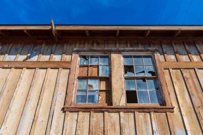 Broken Windows on a Wood Building with a Blue Sky Stock Photo - Image ...