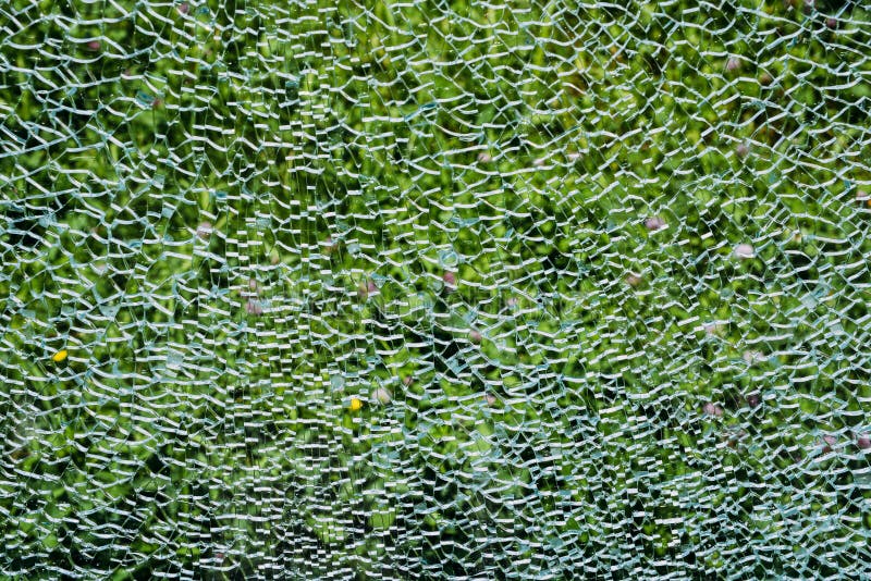 Broken Windshield Glass on a Green Background. Stock Photo - Image of ...