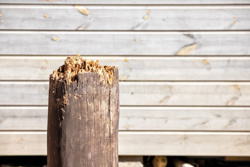 A Broken Wooden Post Against a Wall of Clapboards Stock Photo - Image ...
