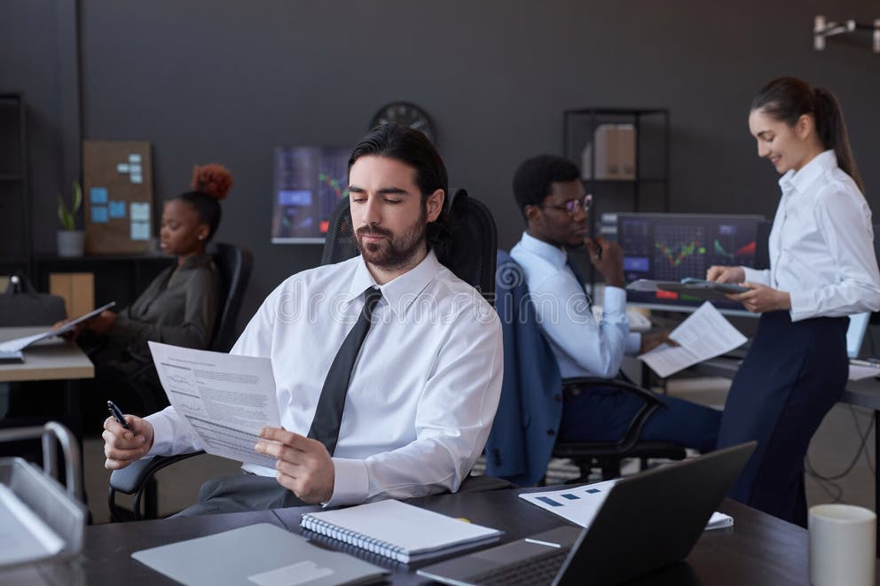 Broker Reading Document in Office Stock Photo - Image of broker ...