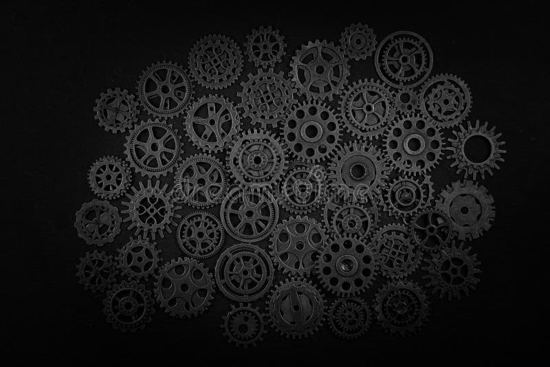 Bronze Cogs and Wheels Arranged on Slate Rock Background Showing ...