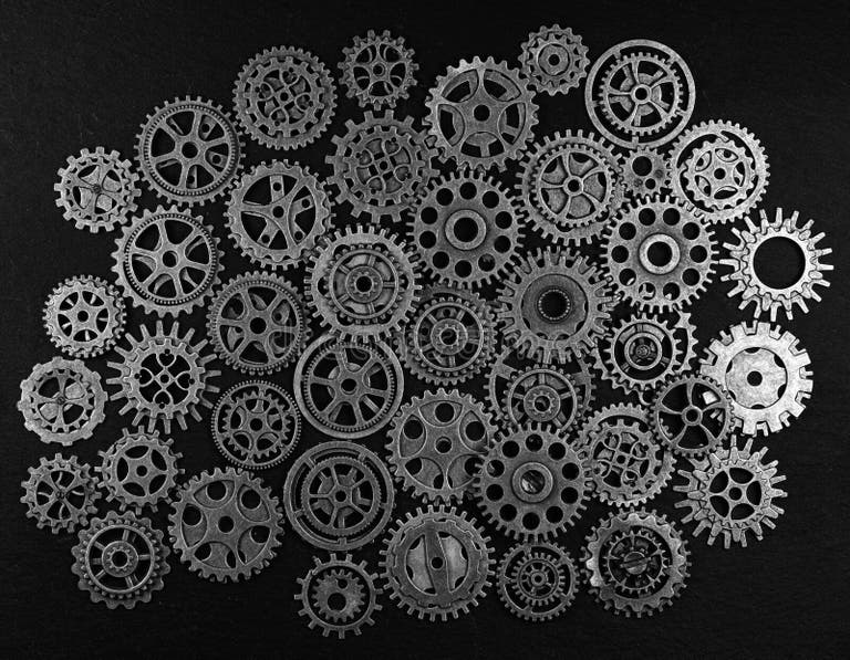 Bronze Cogs and Wheels Arranged on Slate Rock Background Showing ...