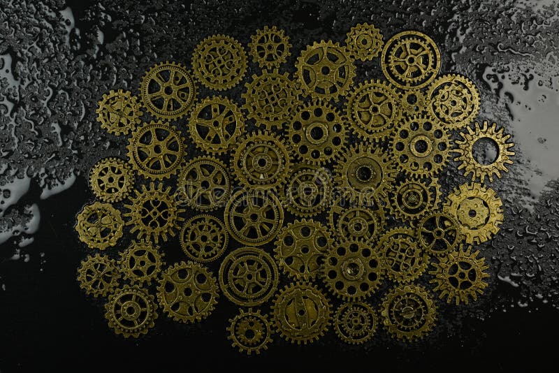 Bronze Cogs and Wheels Arranged on Slate Rock Background Showing ...