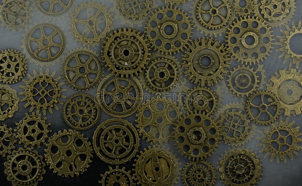 Bronze Cogs and Wheels Arranged on Slate Rock Background Showing ...