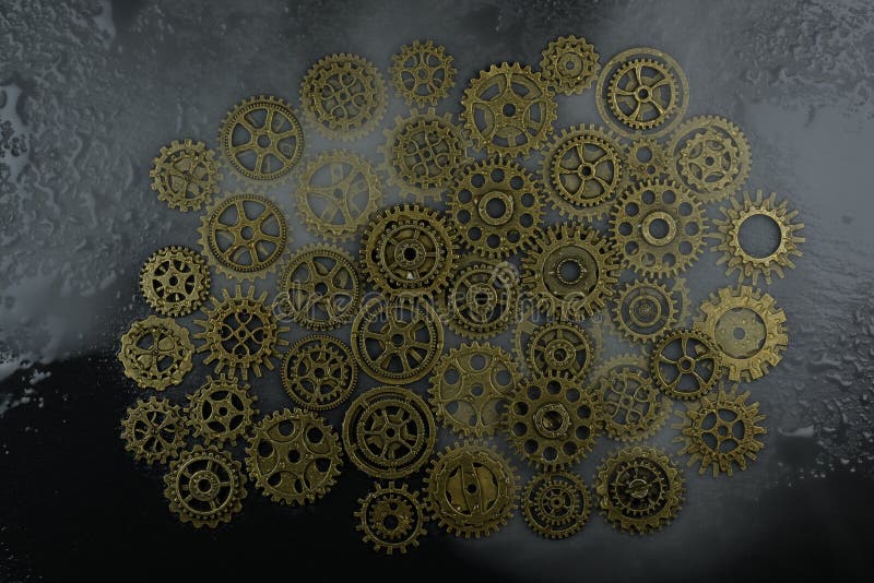 Bronze Cogs and Wheels Arranged on Slate Rock Background Showing ...