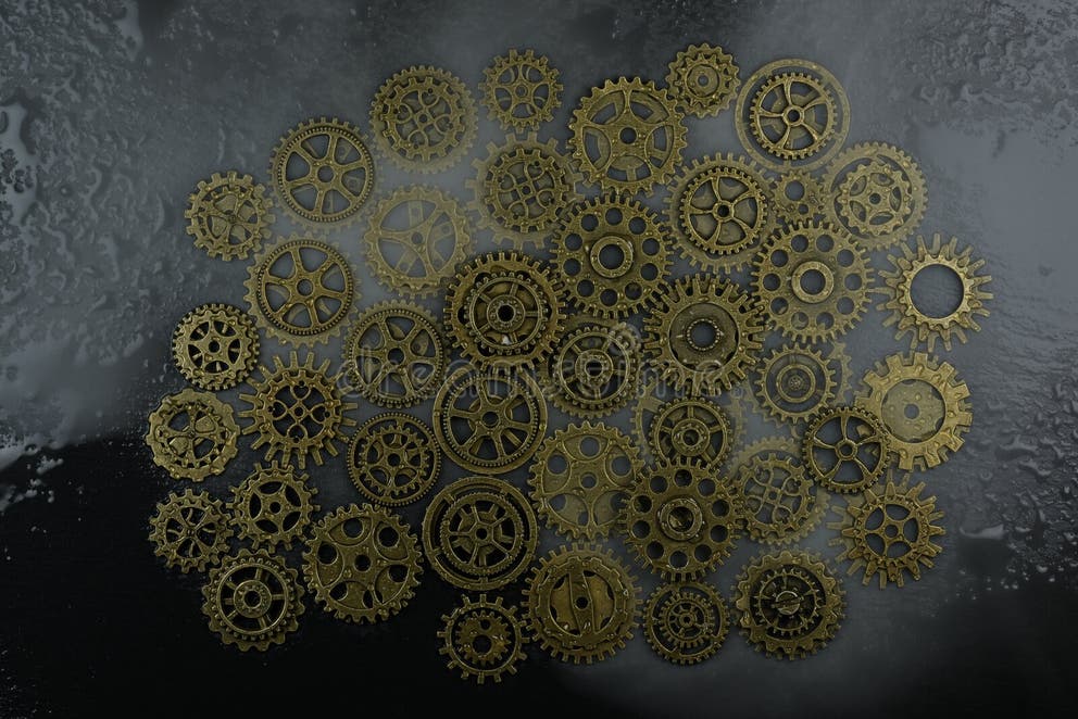 Bronze Cogs and Wheels Arranged on Slate Rock Background Showing ...