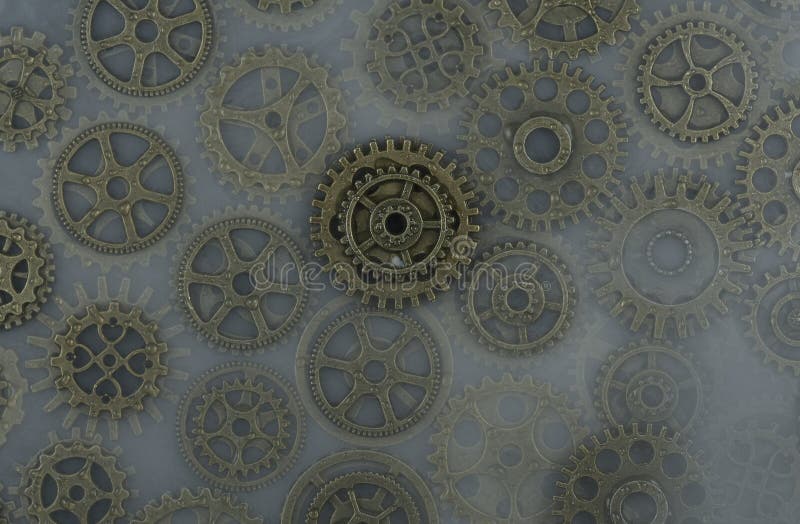 Bronze Cogs and Wheels Arranged on Slate Rock Background Showing ...