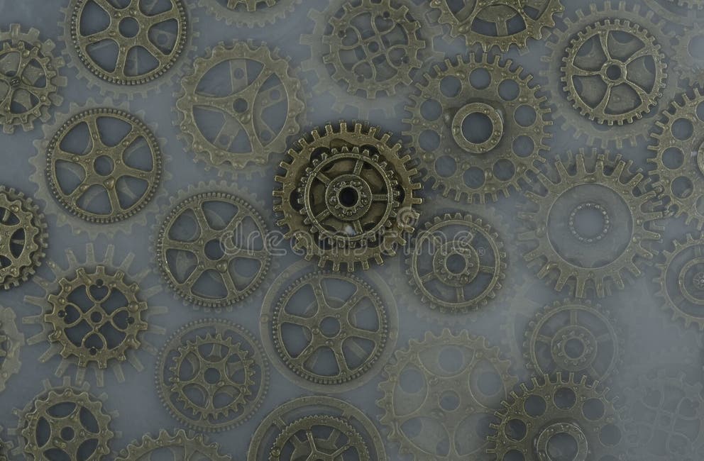 Bronze Cogs and Wheels Arranged on Slate Rock Background Showing ...