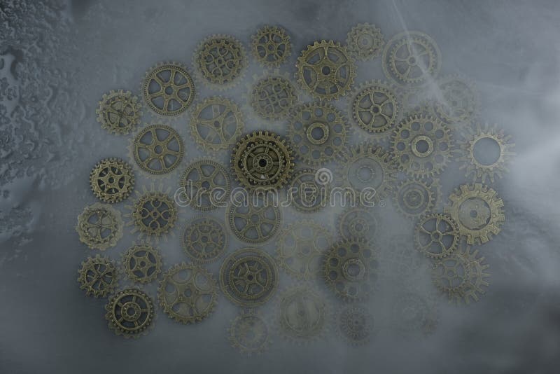 Bronze Cogs and Wheels Arranged on Slate Rock Background Showing ...