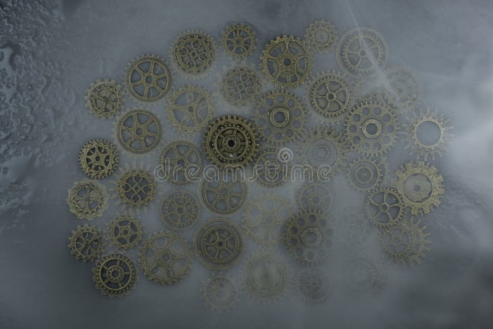 Bronze Cogs and Wheels Arranged on Slate Rock Background Showing ...
