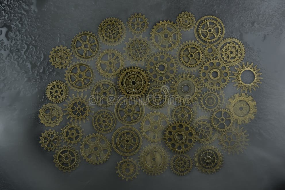 Bronze Cogs and Wheels Arranged on Slate Rock Background Showing ...