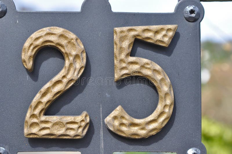 A Bronze Coloured Metallic Digit Fixed on a Dark Background Wall and ...