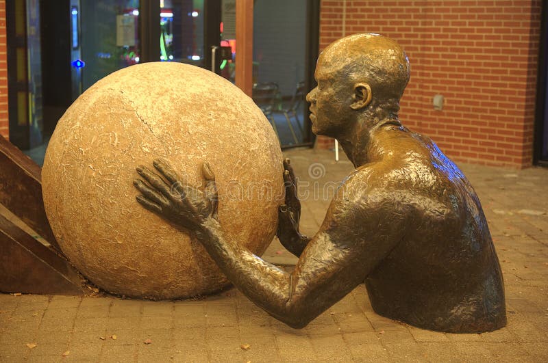 Bronze man with a ball editorial stock photo. Image of structures ...